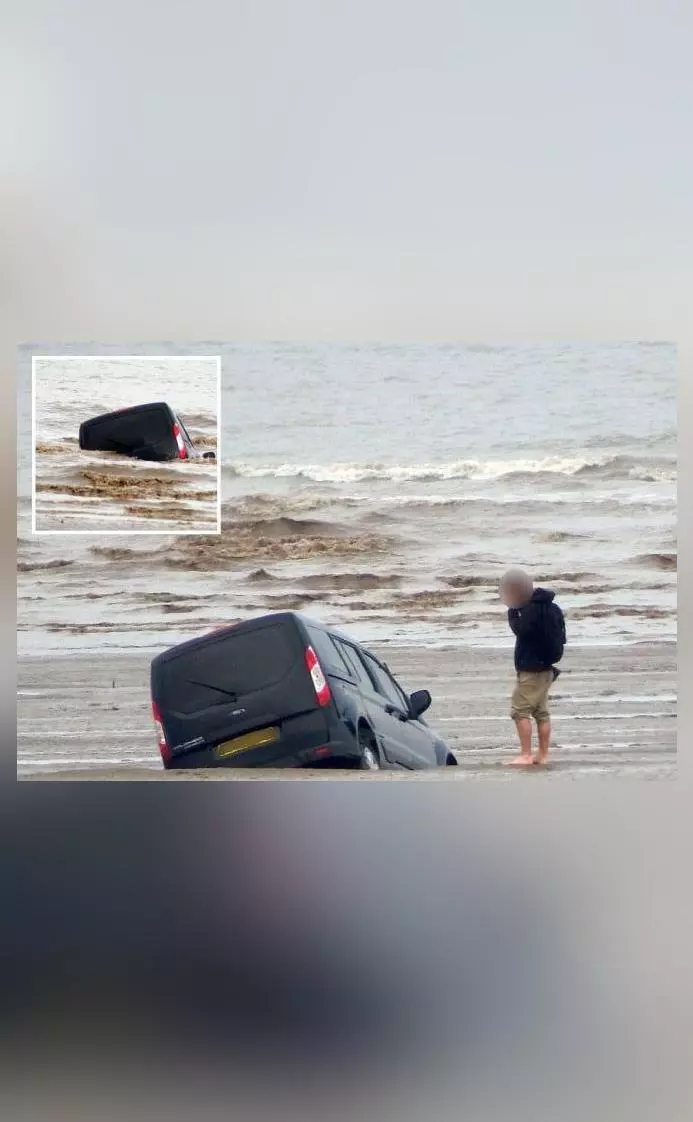 Man watches as his car sinks into beach sand, submerges beneath sea ...